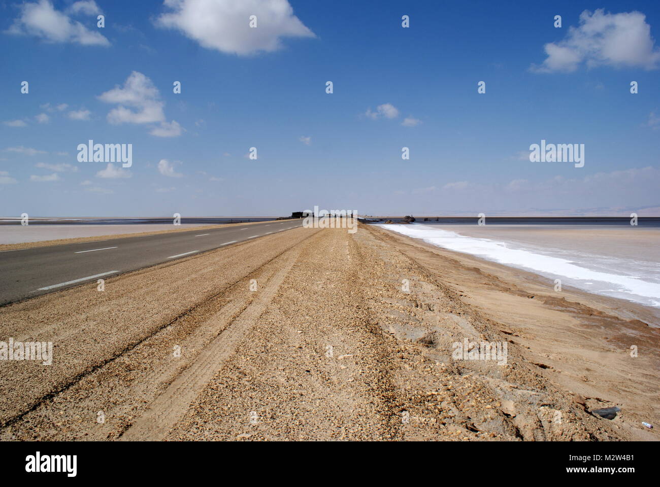 Road running across the Chott el Djerid, a large salt lake in southern ...