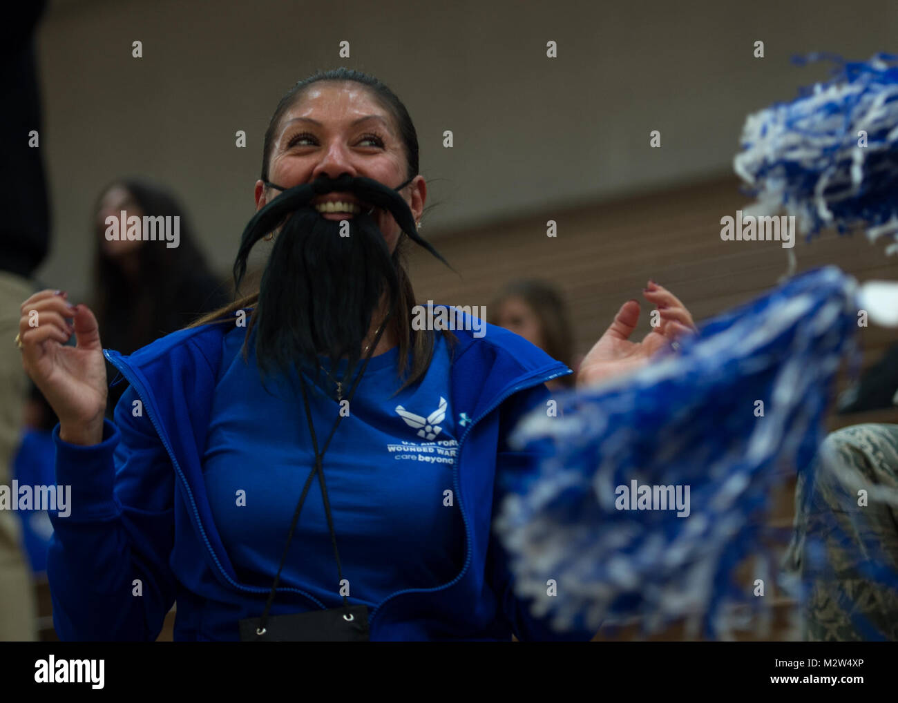 Anna Carter, wife of Air Force athlete Corey Carter, tries on a fake ...
