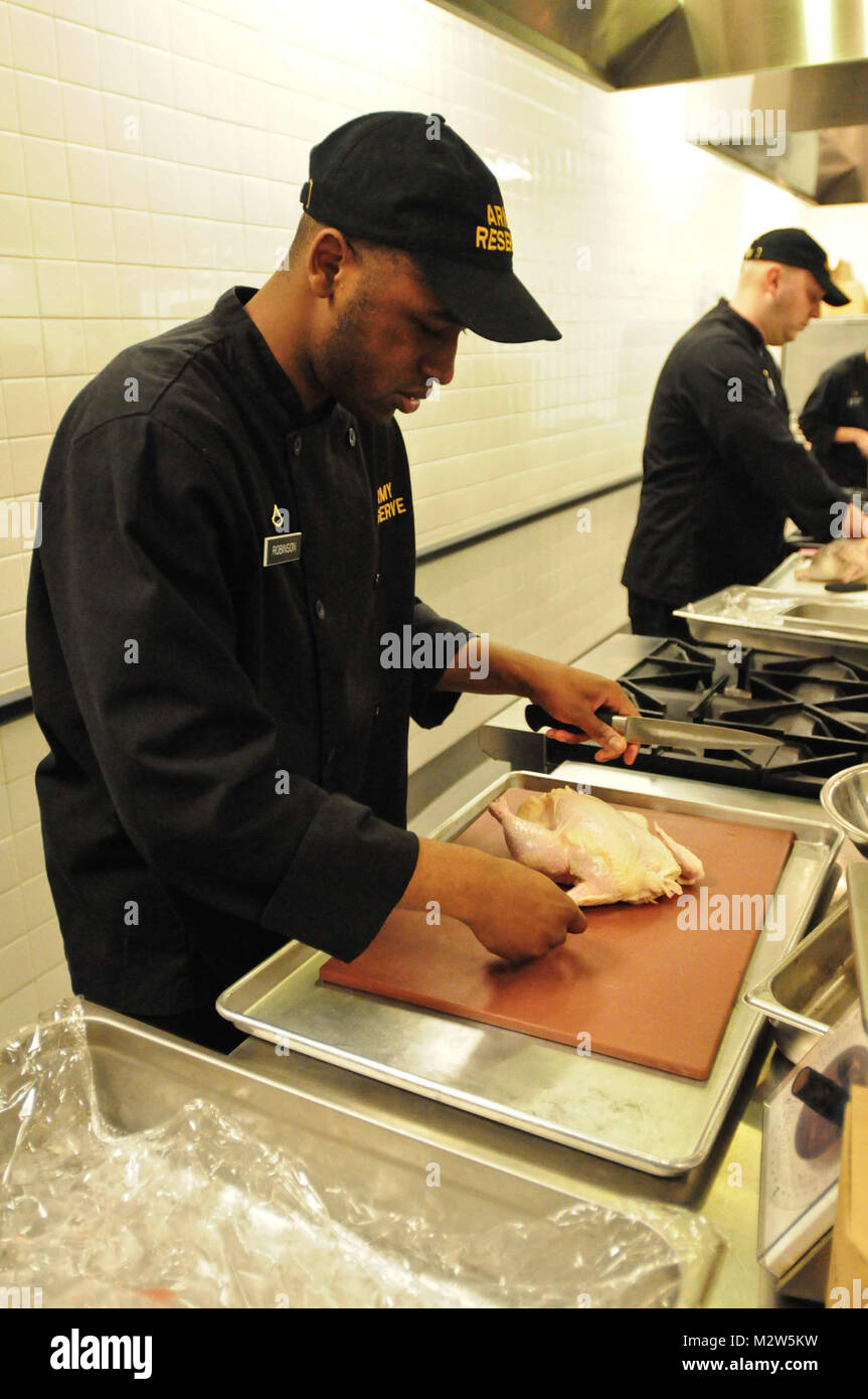 Pfc. Christopher Robinson from Meridian, Idaho, begins to cut his ...