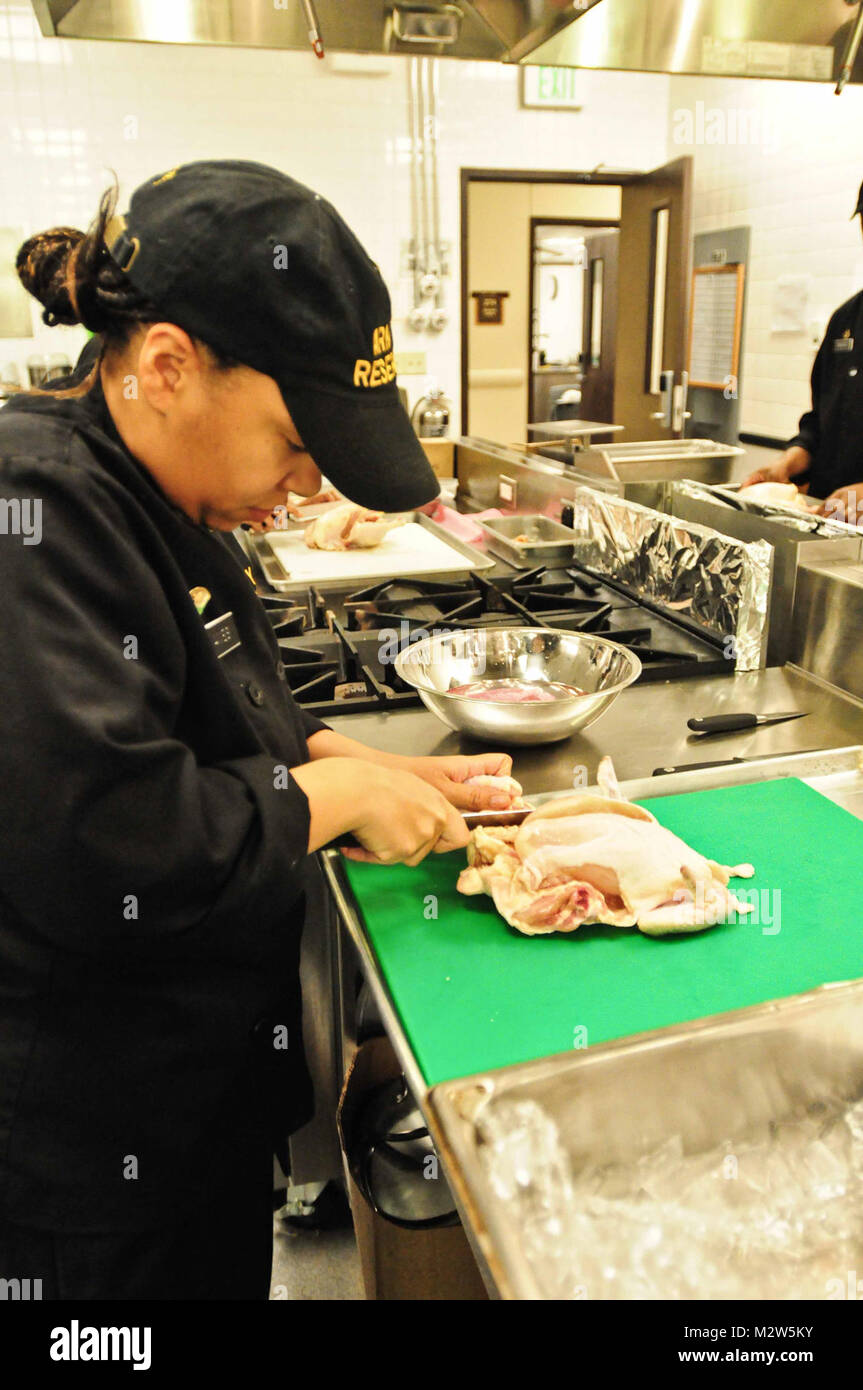 Spc. Aquillah James from Atlanta cuts a chicken in the Army Reserve ...