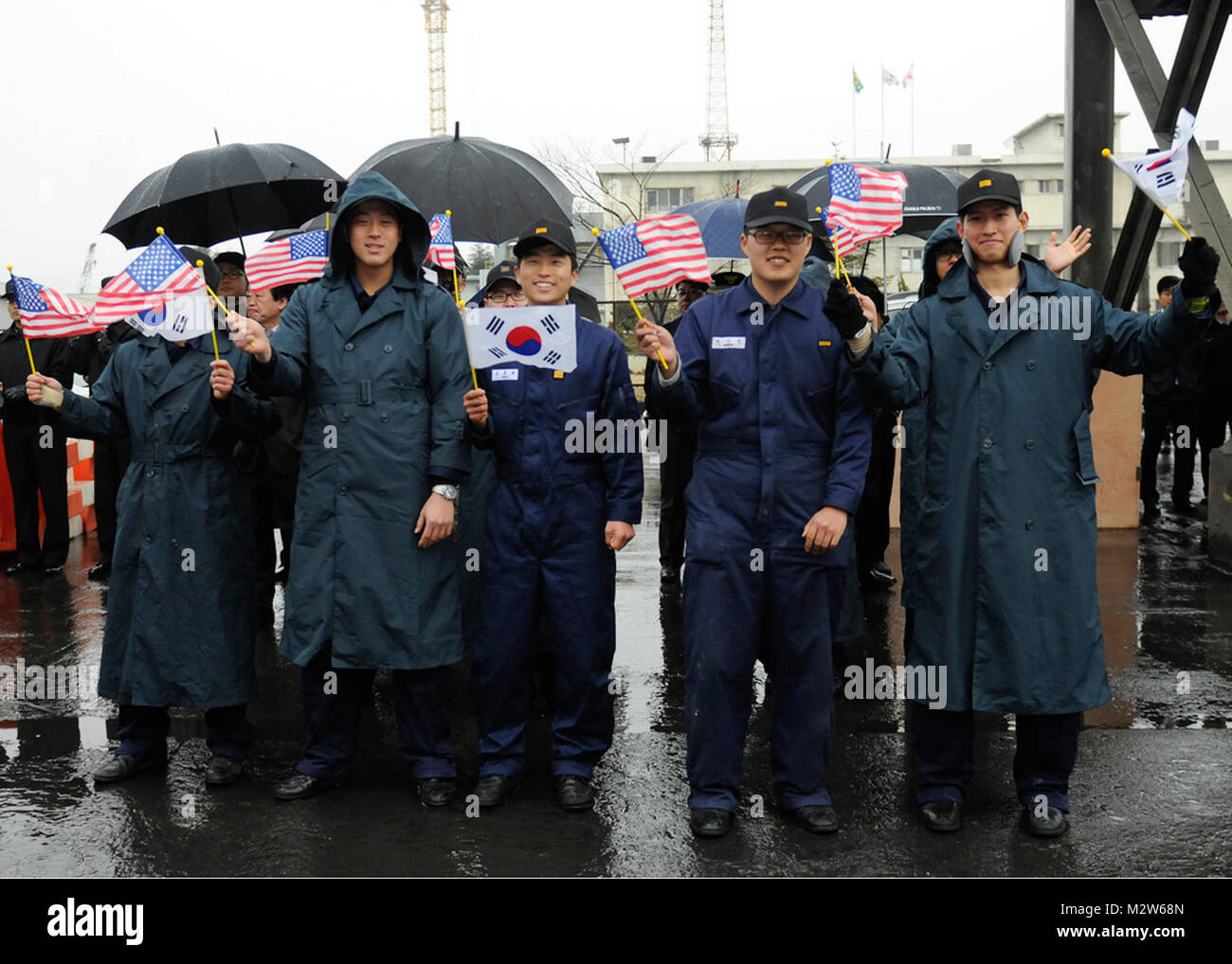 Republic of Korea navy sailors wave flags as U.S. 7th Fleet flagship ...