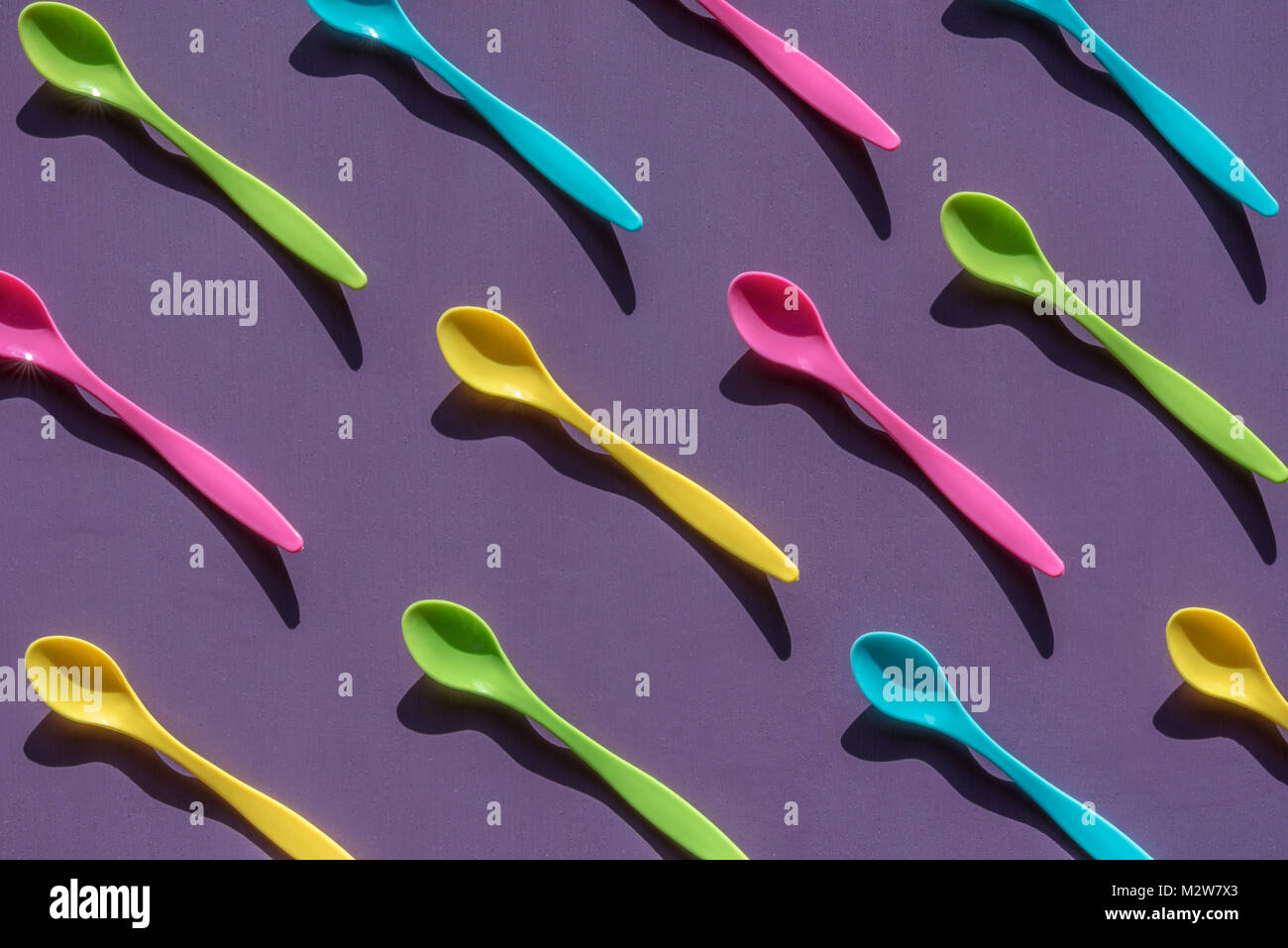 Gastronomy banner idea with a bunch of plastic small spoons, in various ...