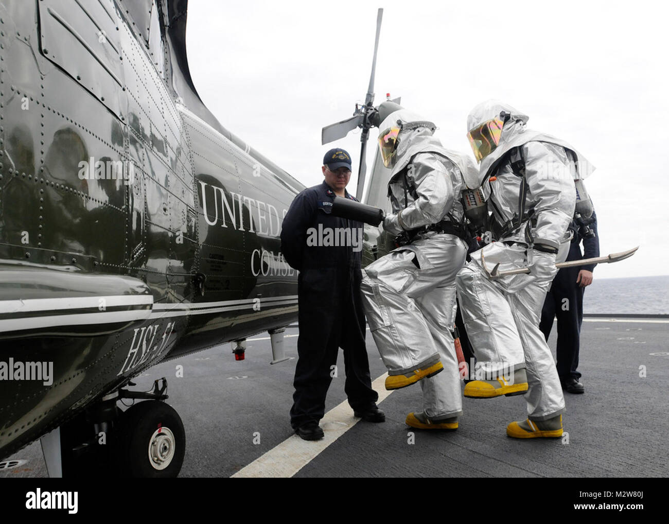 Salvage team proper firefighting techniques during a helicopter ...
