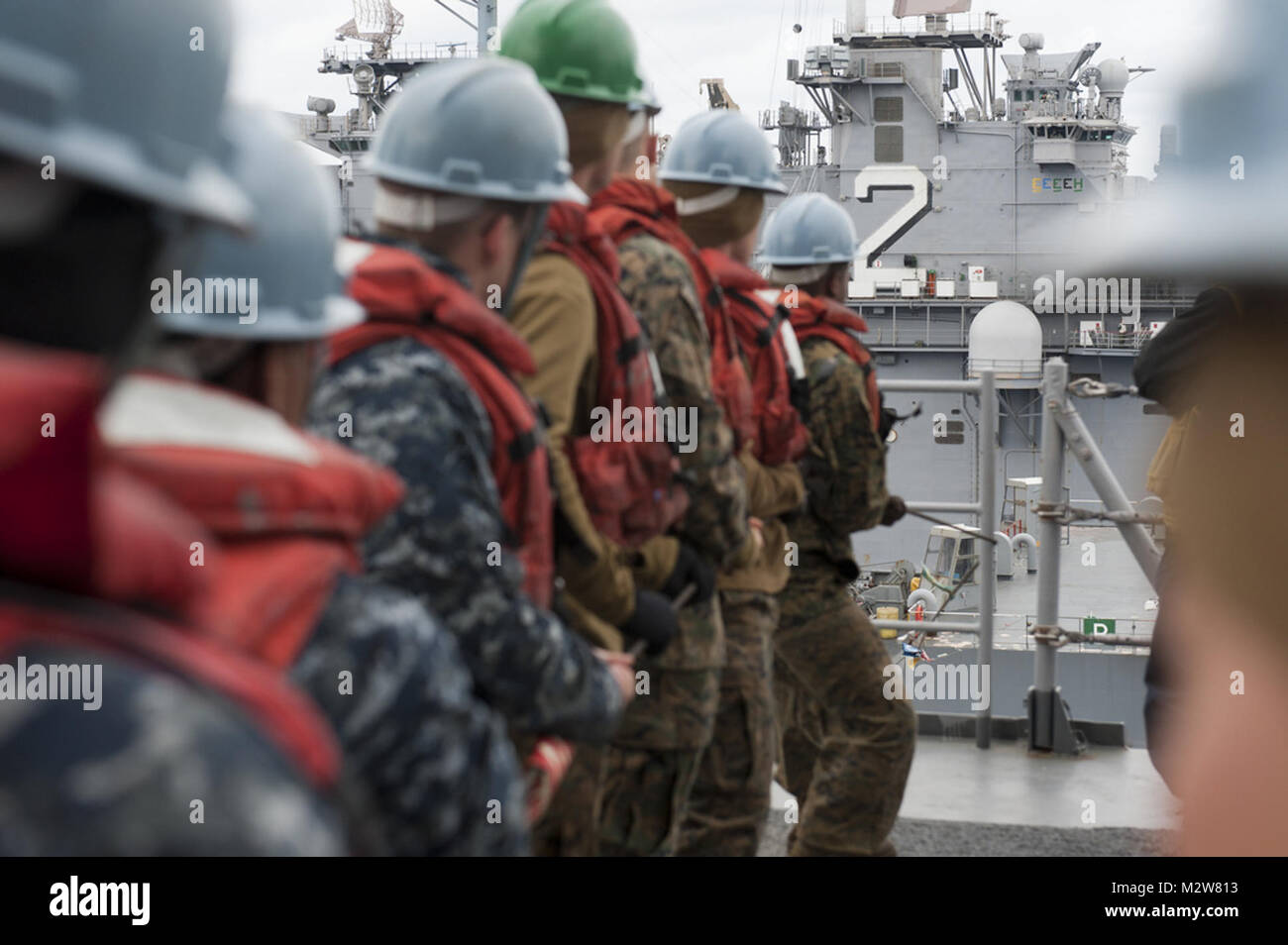 Sailors and Marines handle the phone and distance line aboard the ...