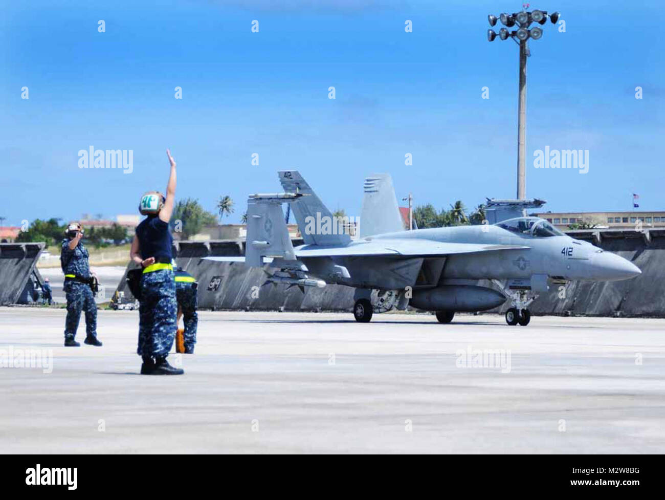A F-18 from Carrier Air Wing Five, Strike Fighter Squadron 195 taxis to ...