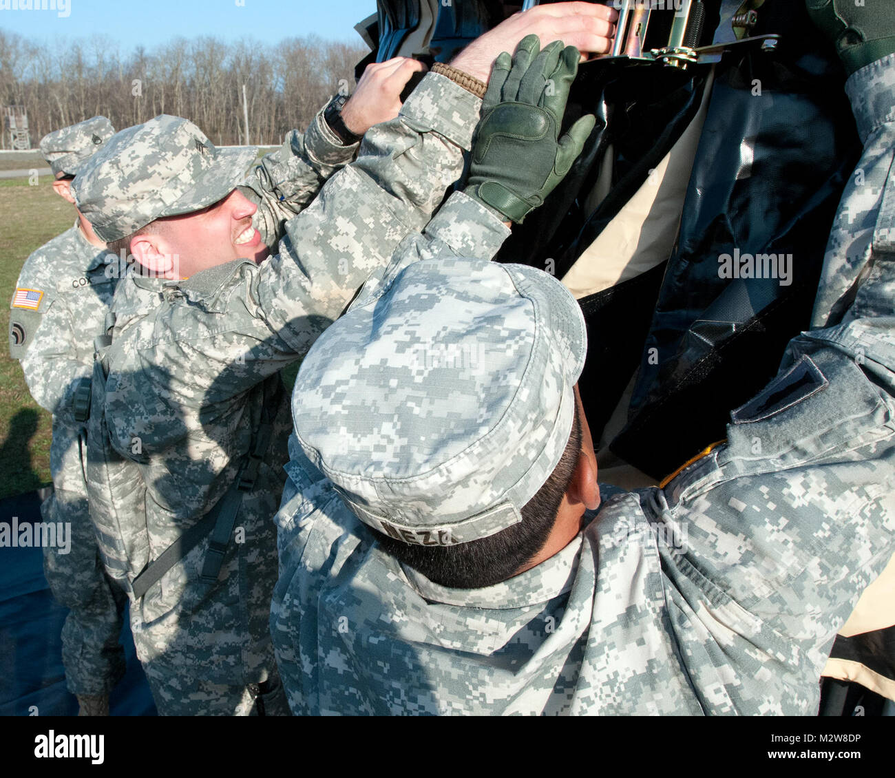 Soldiers of the 316th ESC remove the straps from a large Trailer ...