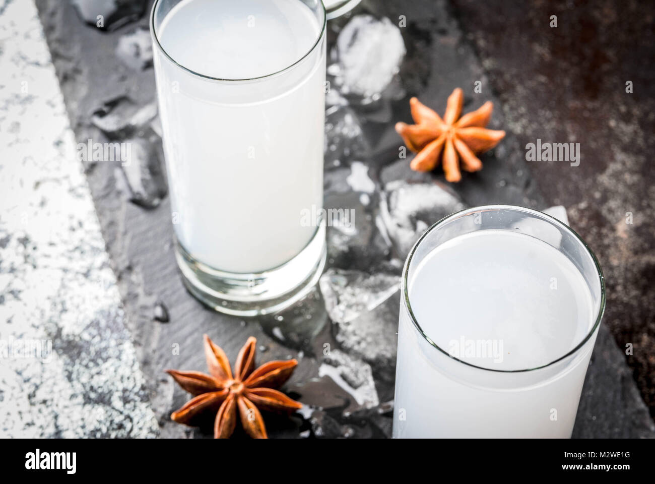Traditional arabic alcohol drink Raki with anise, dark rusty background ...