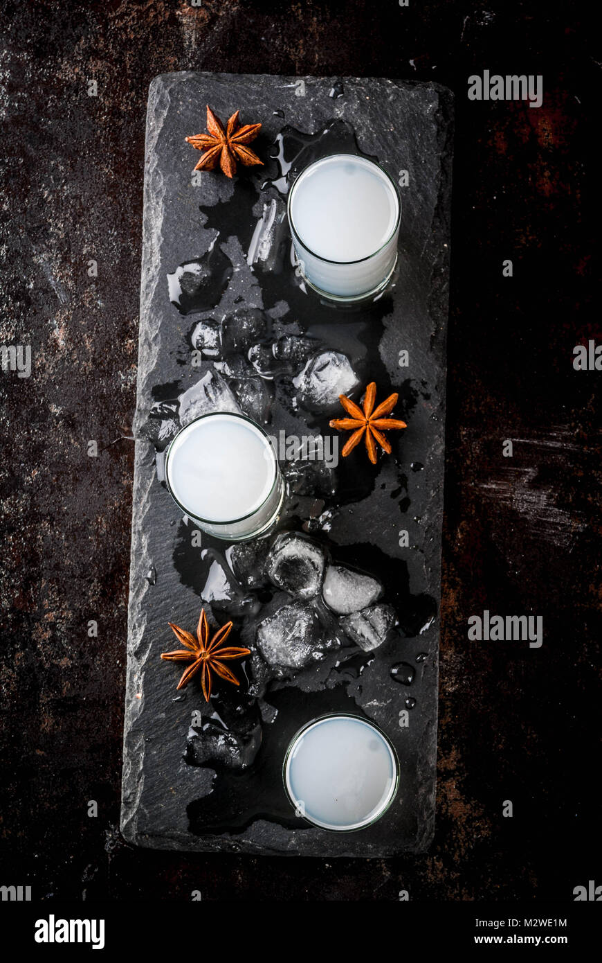 Traditional arabic alcohol drink Raki with anise, dark rusty background ...