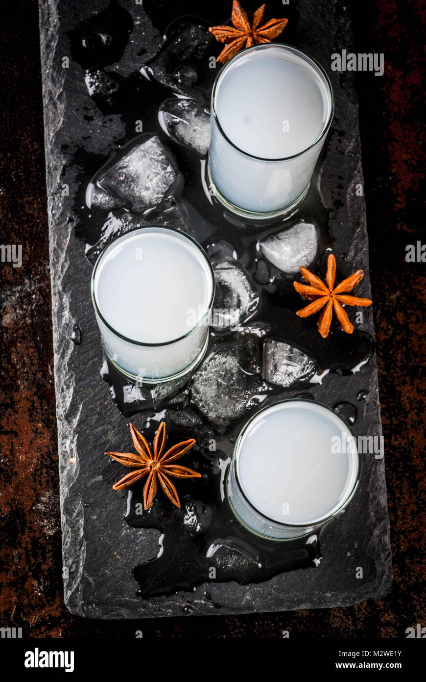 Traditional arabic alcohol drink Raki with anise, dark rusty background ...