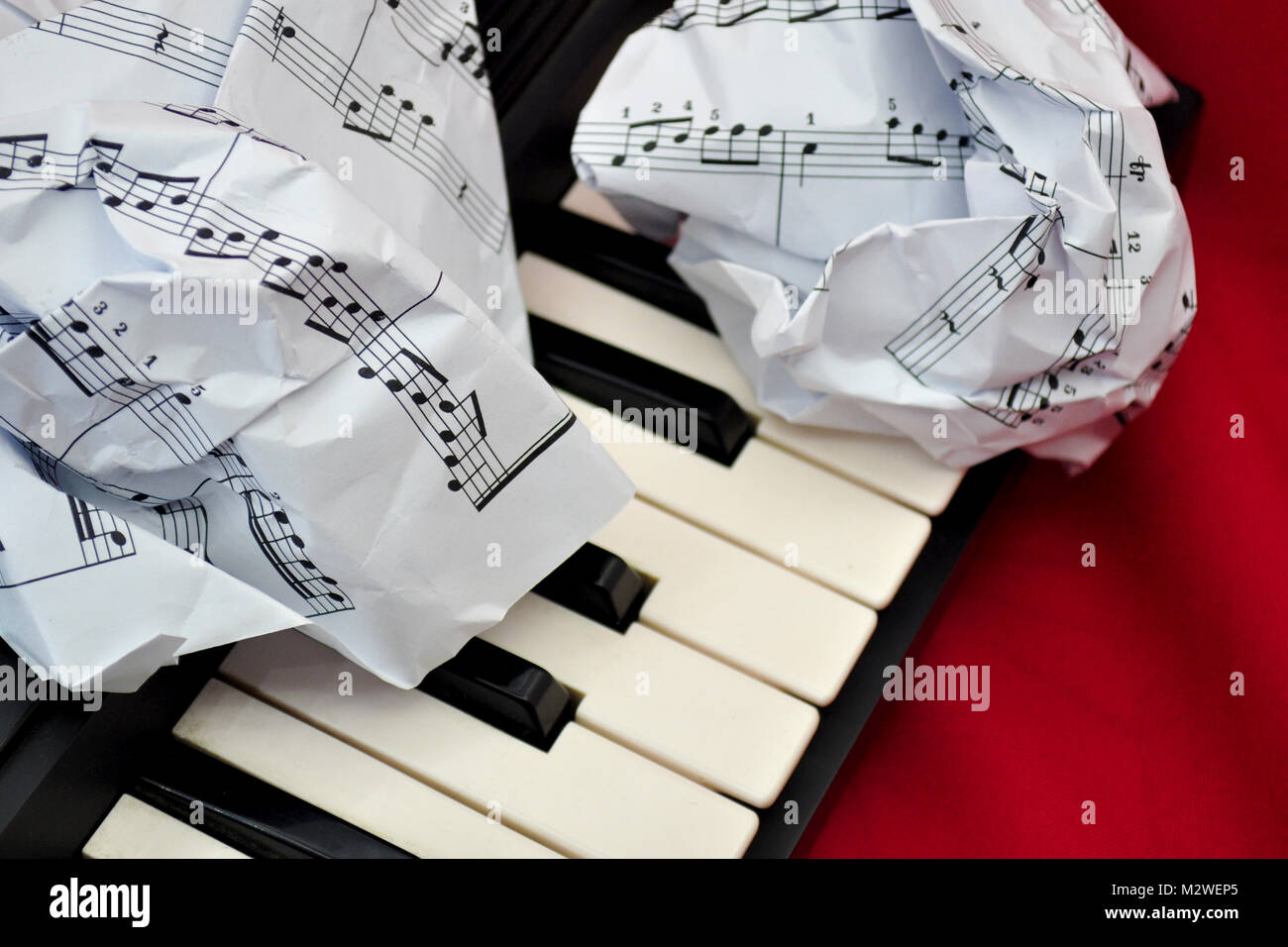 Wrinkled musical sheet on red background Stock Photo - Alamy