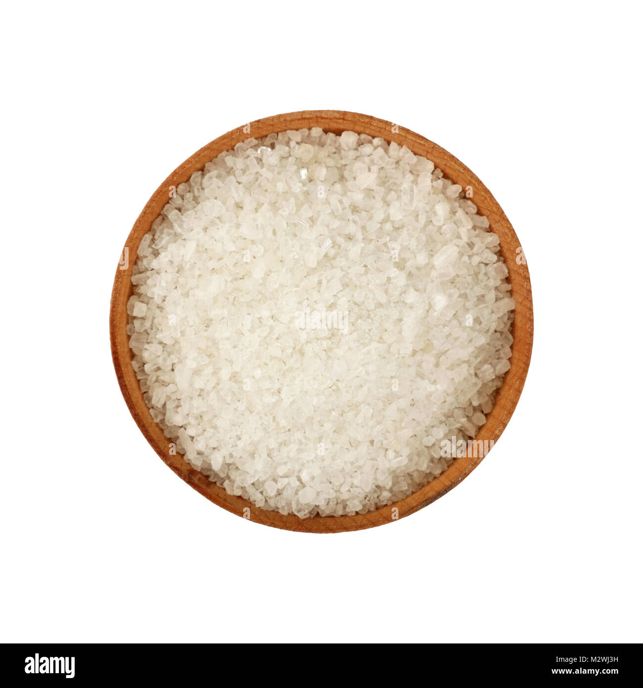 Close up one wooden bowl full of white marine rock salt isolated on ...