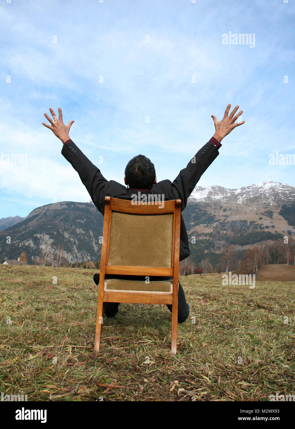 man alone sitted on a chair into the nature Stock Photo - Alamy