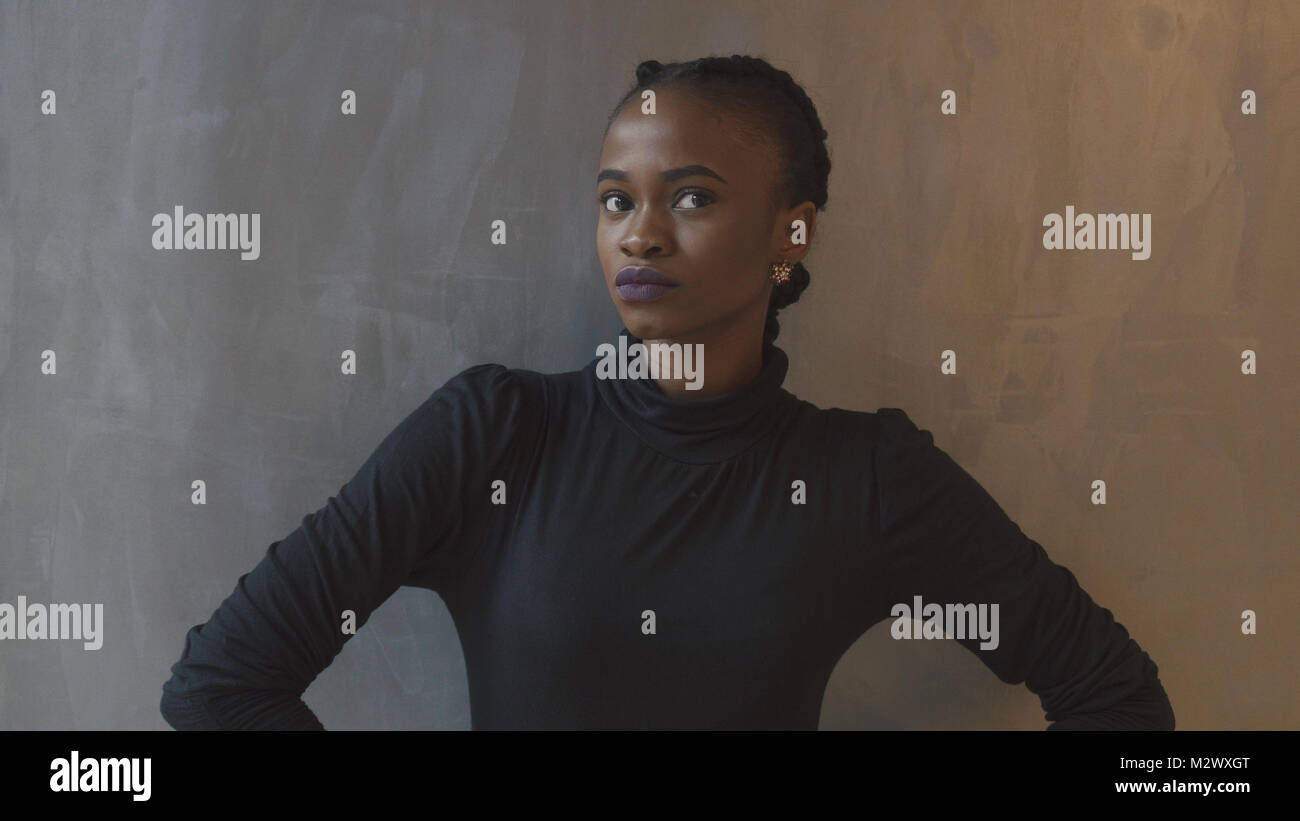 Portrait of the young calm african woman with purple lipstick and ...