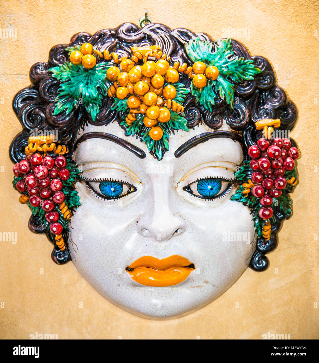 Ceramic female head set in a wall along the streets of Taormina. Sicily ...