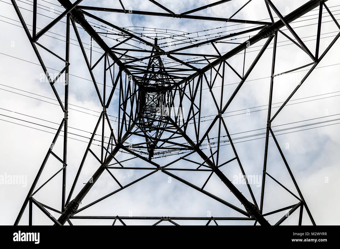 View from beneath electricity pylon with graphic pattern of steel ...