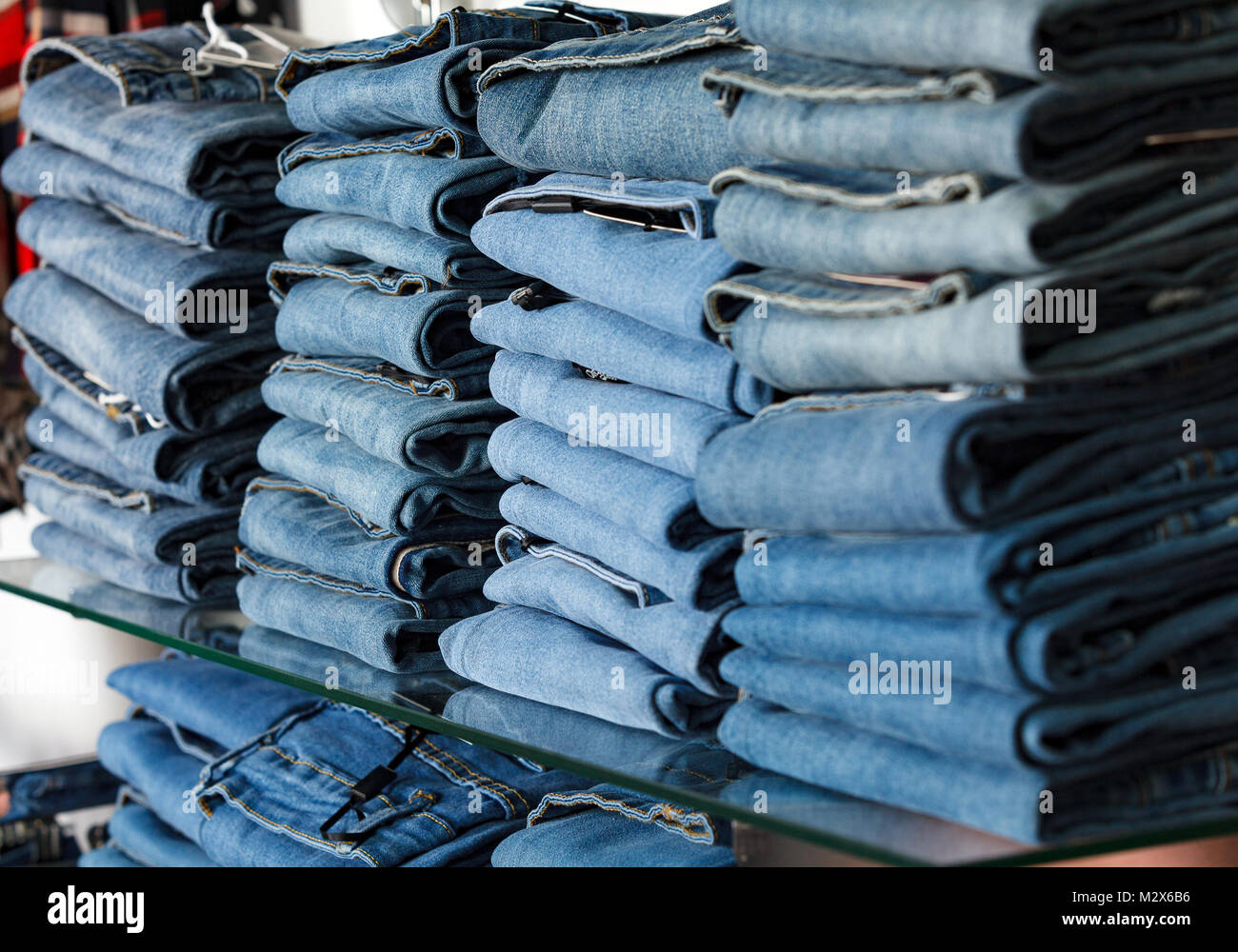 Closeup shot of stack of folded jeans in the fashion store Stock Photo ...