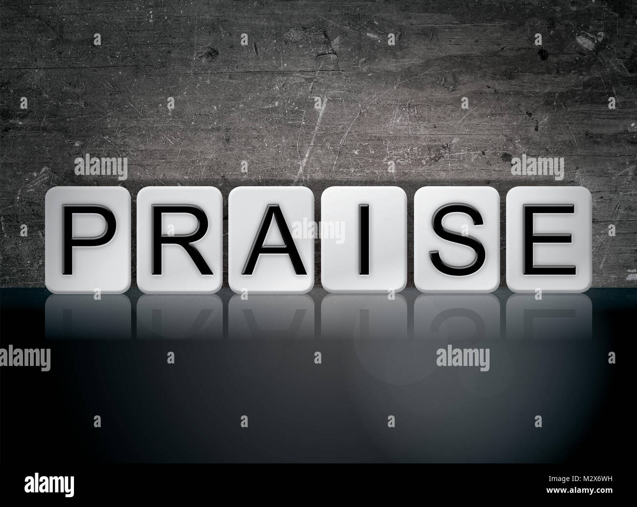 The word Praise concept and theme written in white tiles on a dark ...