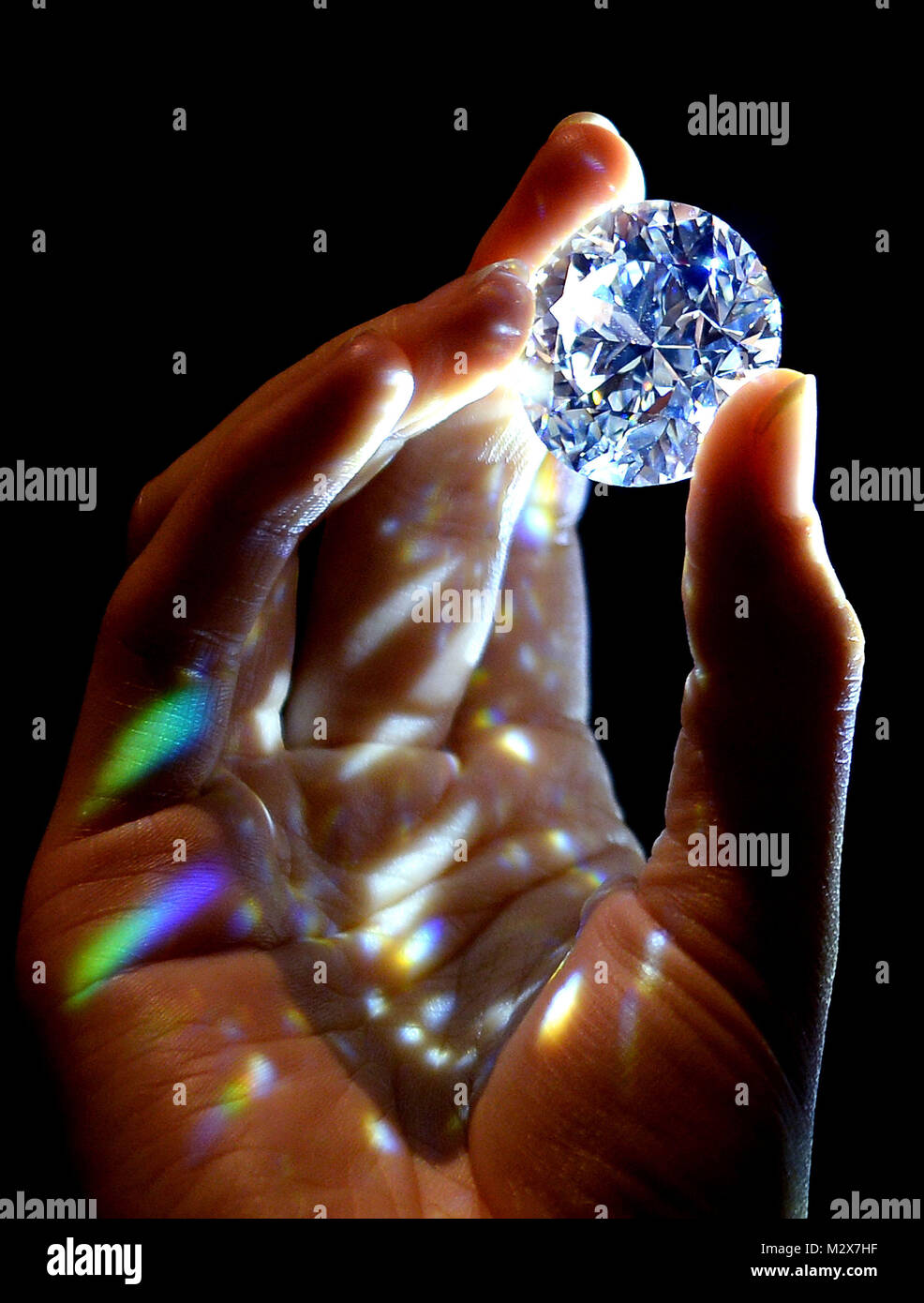 A model holds a 102.34 carat white diamond, described as the rarest ...