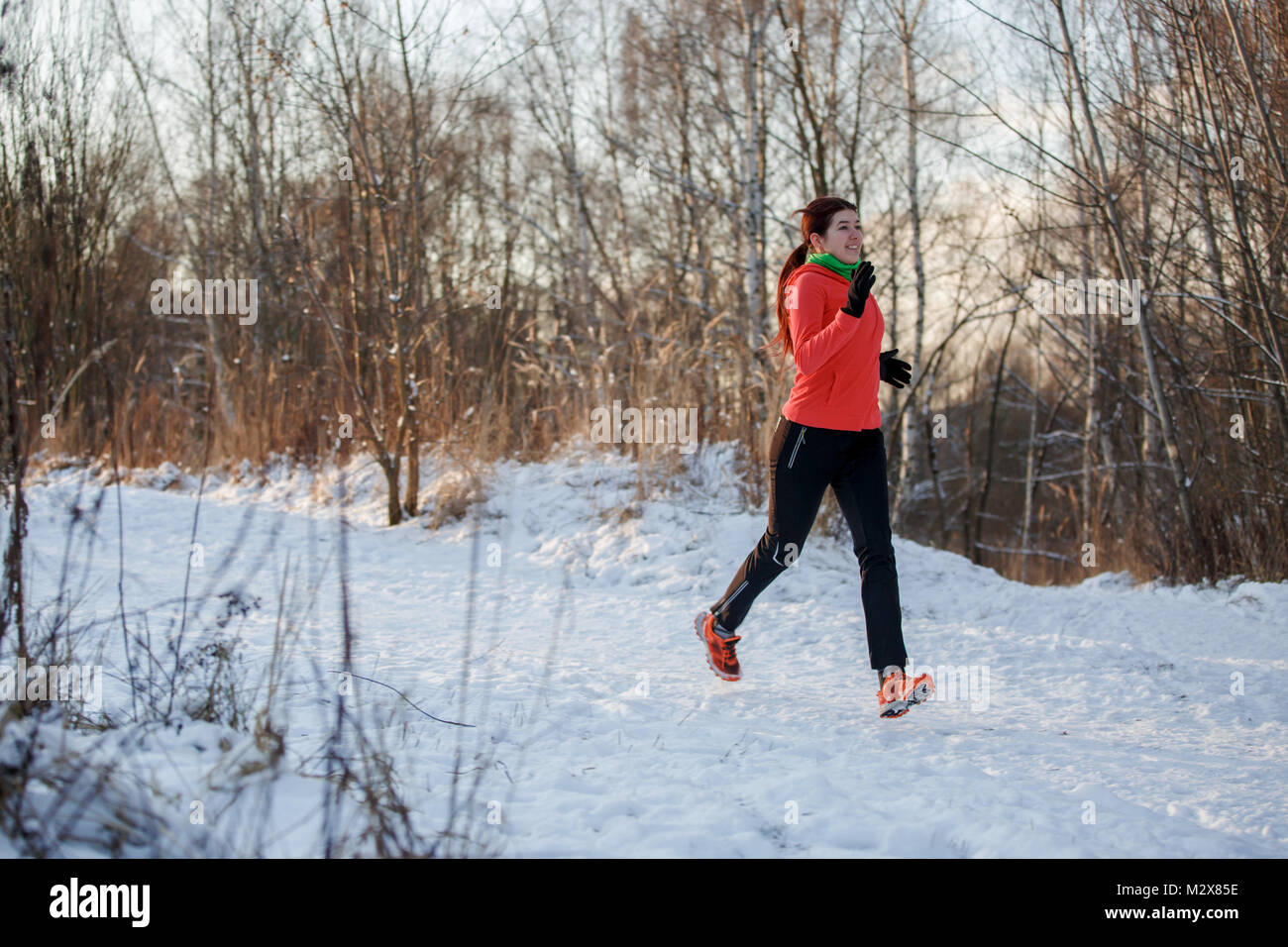 Girl athlete running in winter park on morning run Stock Photo - Alamy