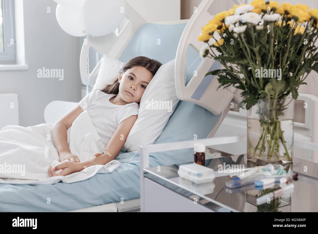 Poor child with drop counter lying on hospital bed Stock Photo - Alamy