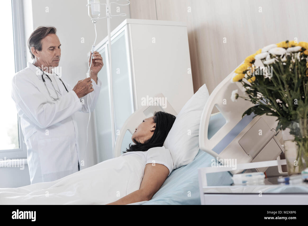 Patient in hospital bed adjusting hi-res stock photography and images ...