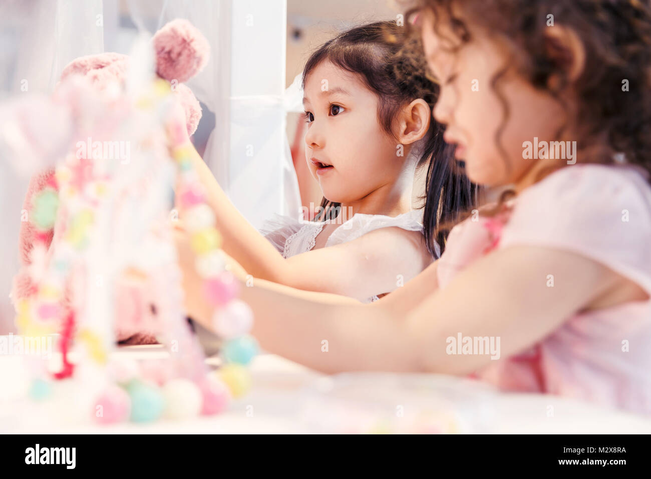 Lovely little girl to play with toy Stock Photo - Alamy