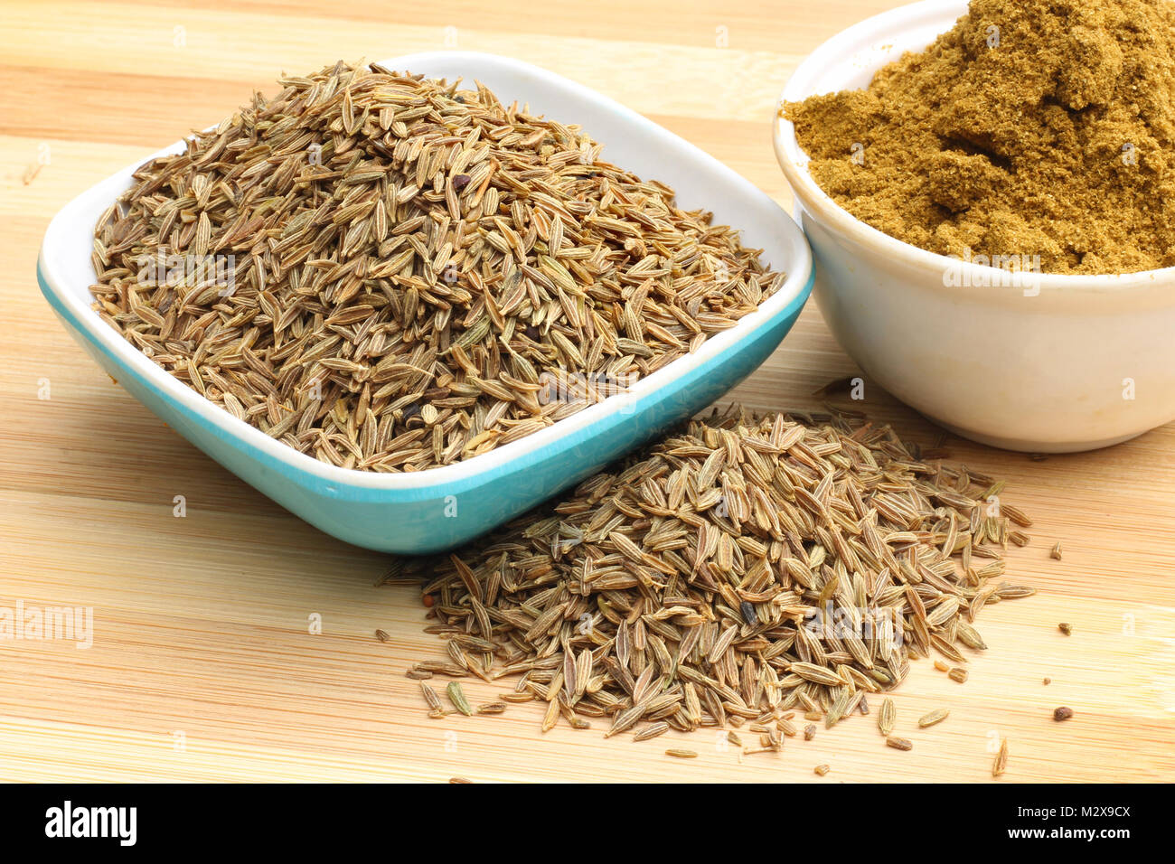 Crushed cumin on wooden background Stock Photo - Alamy