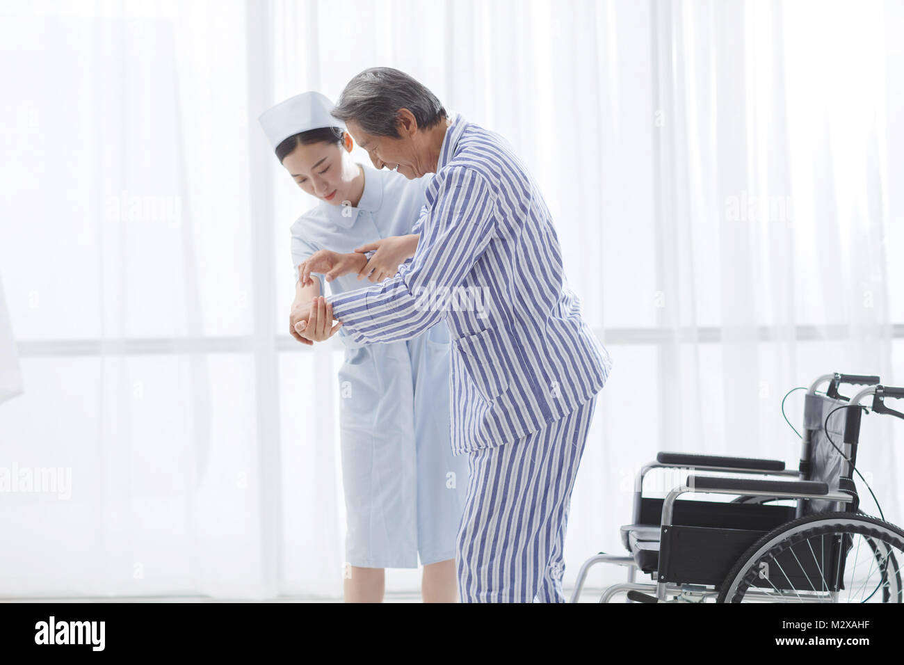 Assist patient walking nurse hi-res stock photography and images - Alamy