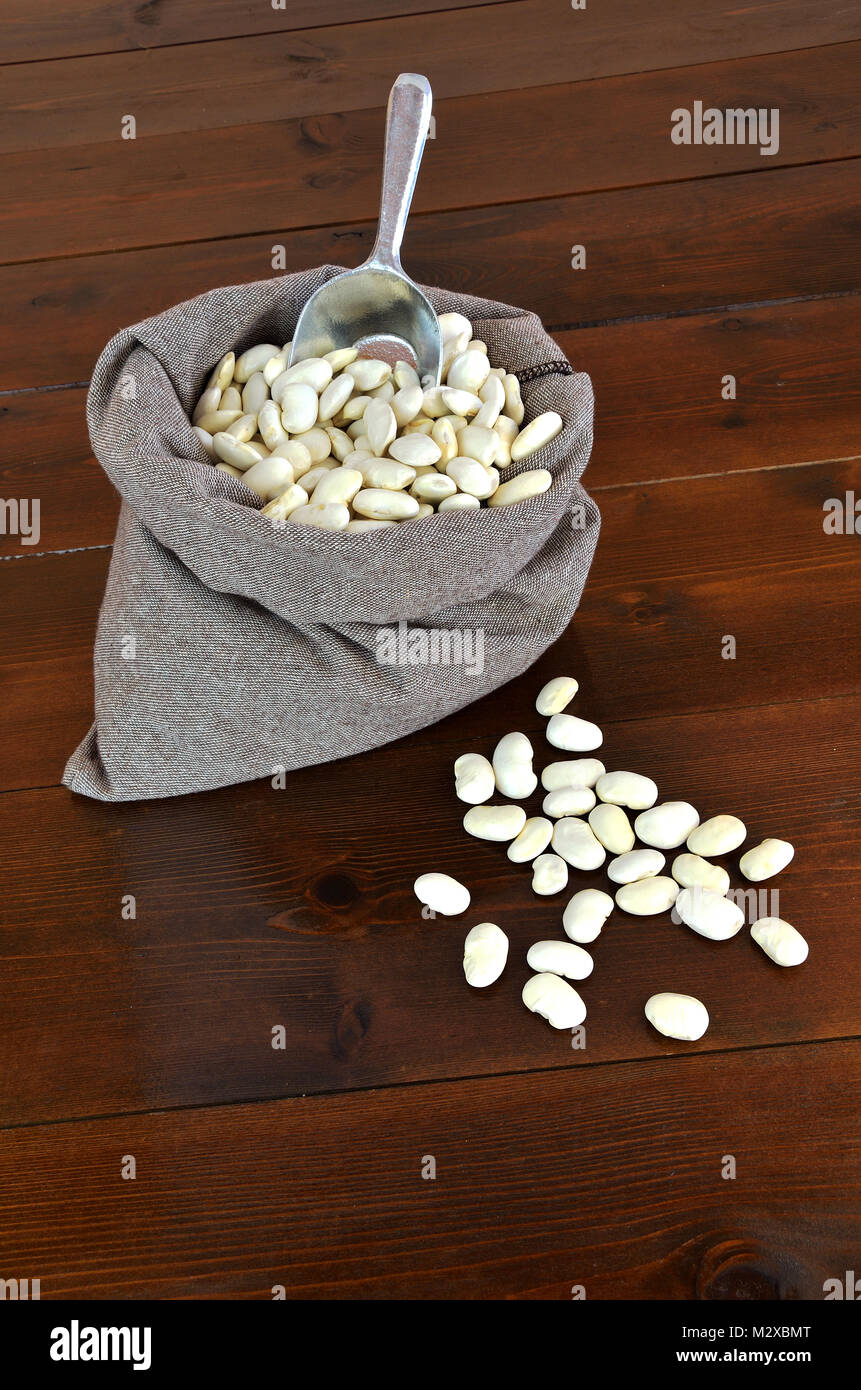 Small bag of Lima beans on a wooden table Stock Photo - Alamy