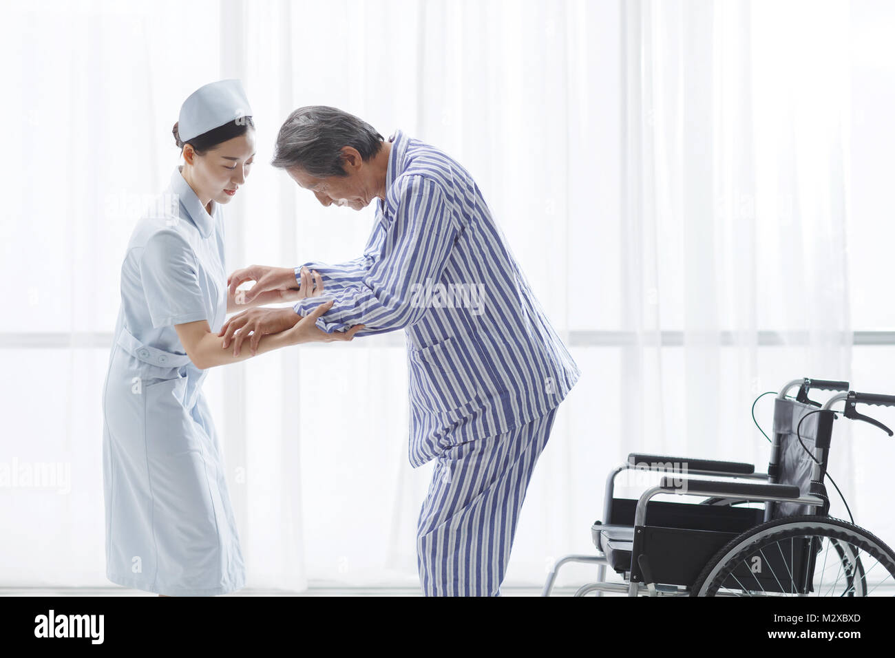 The nurse to assist the patient rehabilitation training Stock Photo - Alamy