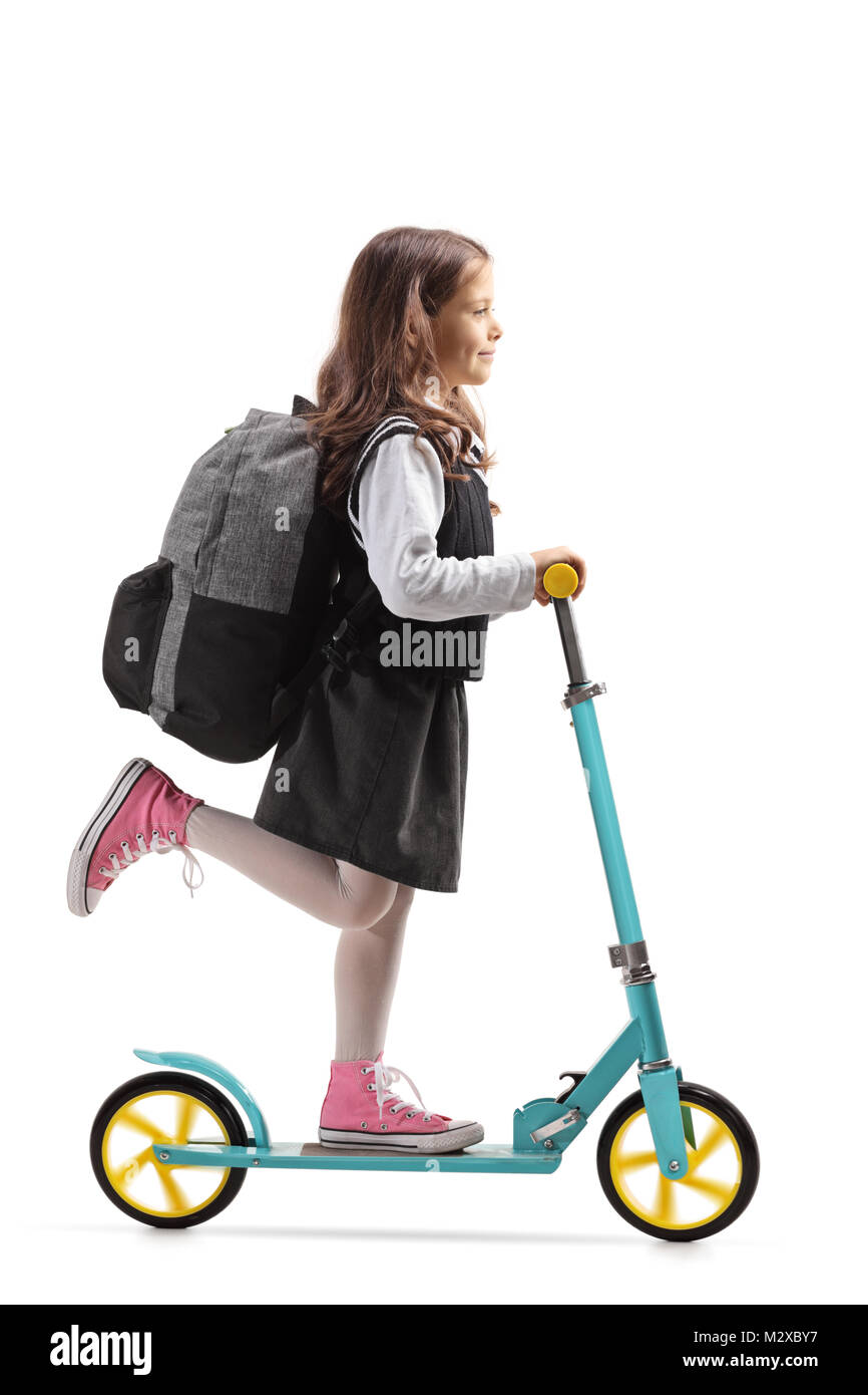 Full length profile shot of a schoolgirl with a backpack riding a ...