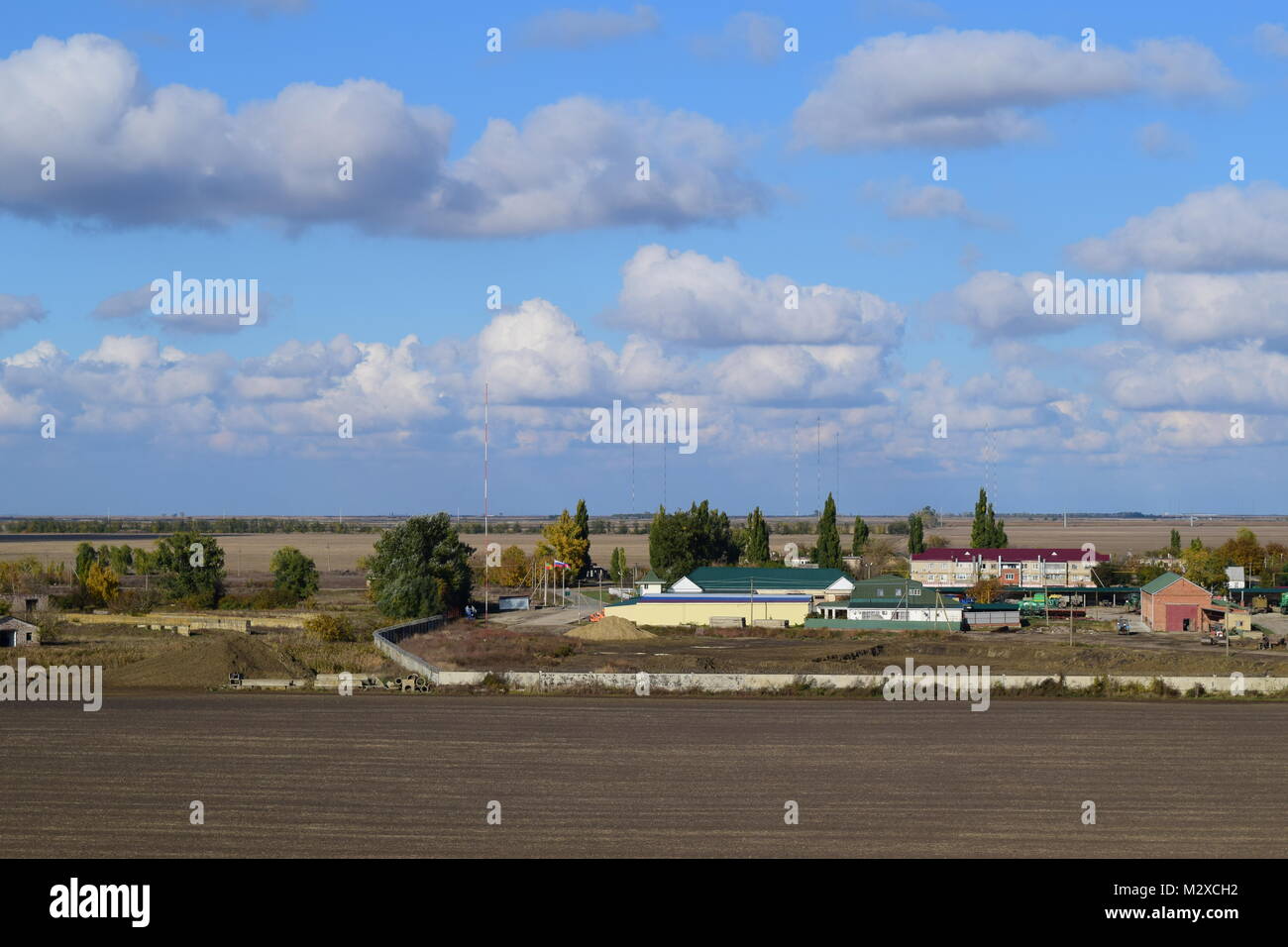A view from above of a small Russian village. Rural landscape. Field ...