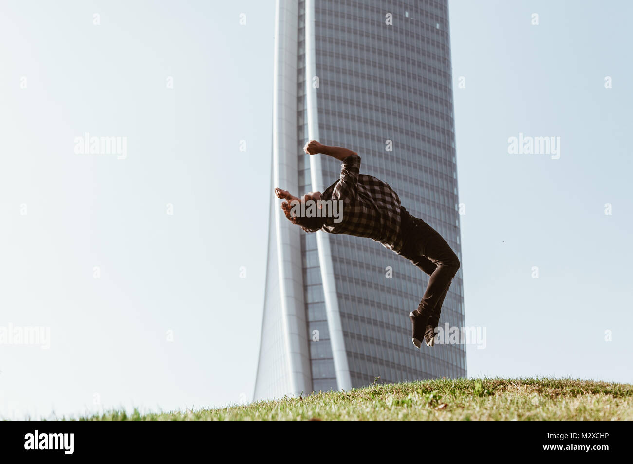 Young boy levitating with modern structure in the background. Super ...