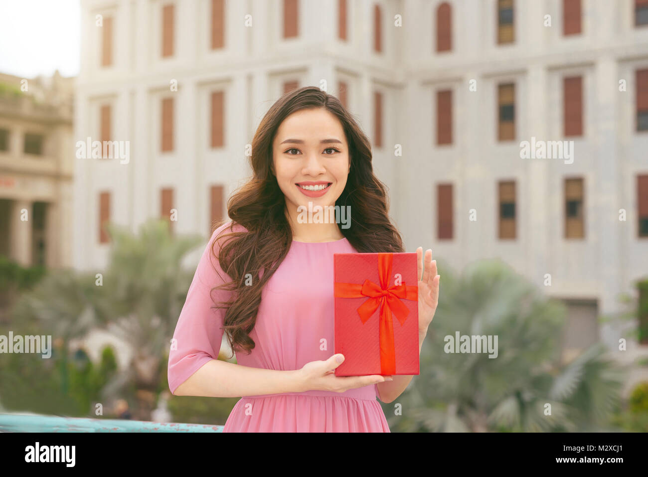 Portrait of young beautiful asian woman with gift box posing in the ...