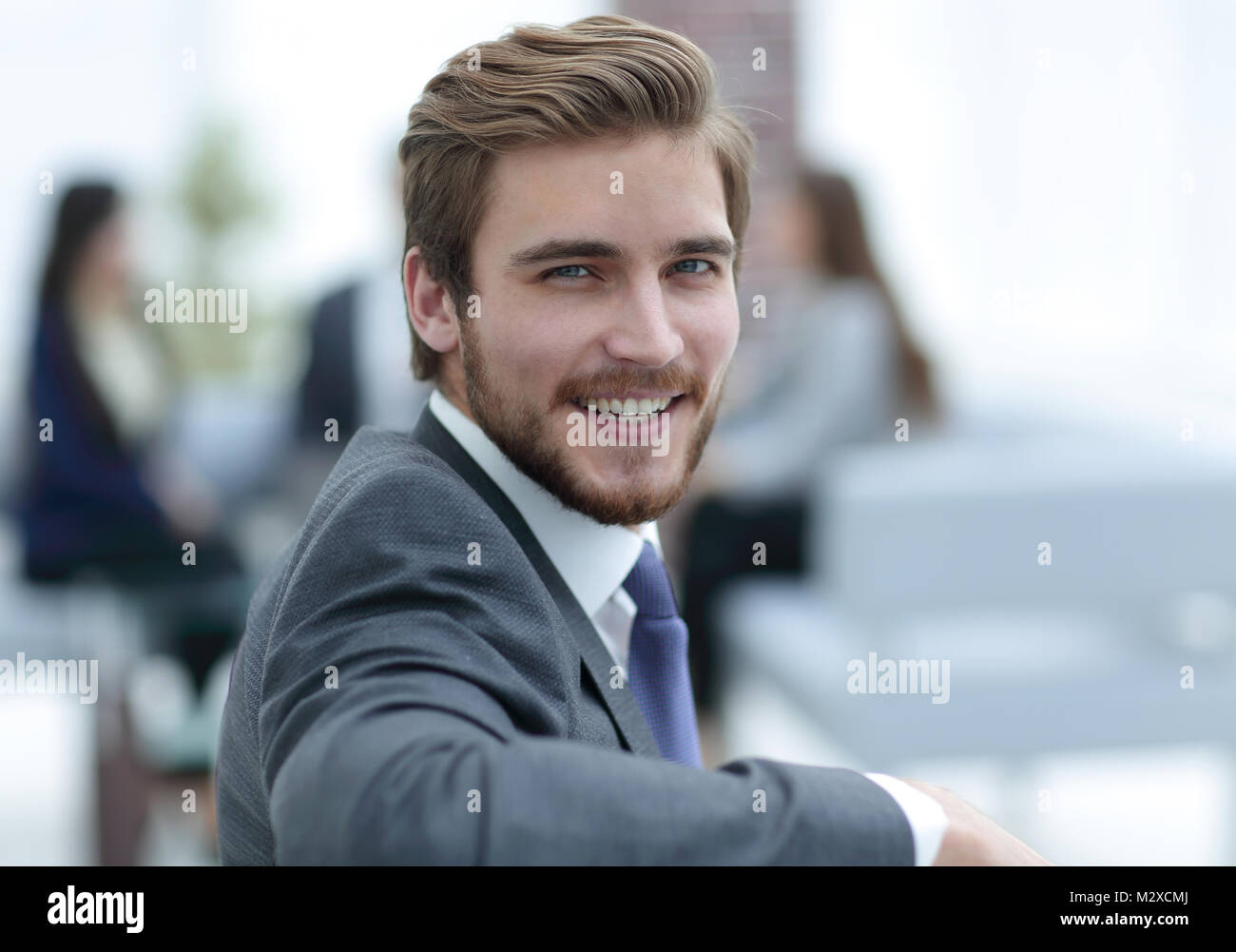 Successful business man standing with his staff in background at Stock ...