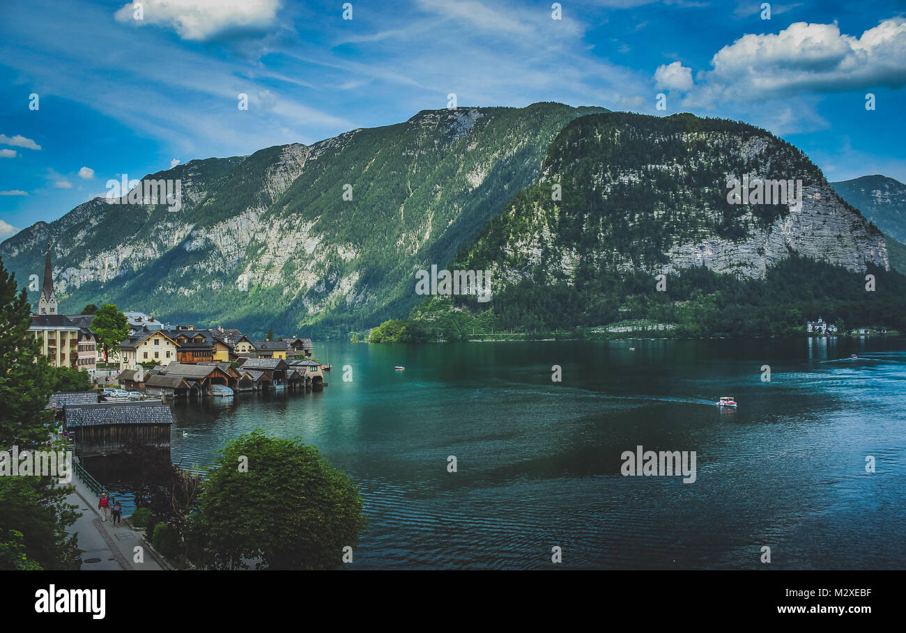 Scenic view of the picturesque Hallstatt lakeside village at the base ...