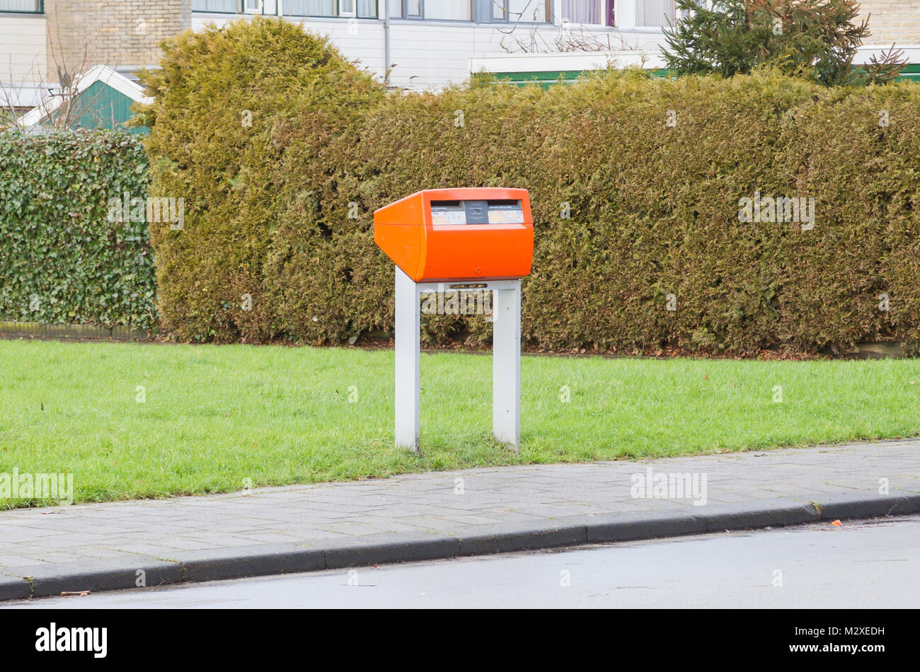 Posting a letter in the Netherlands - Orange letterbox Stock Photo - Alamy