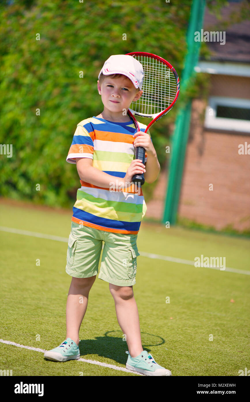 Portrait of cute little tennis player on tennis court Stock Photo - Alamy