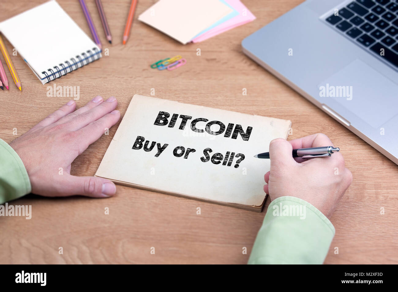 Bitcoin, buy or sell. Office desk with a laptop and stationery Stock ...