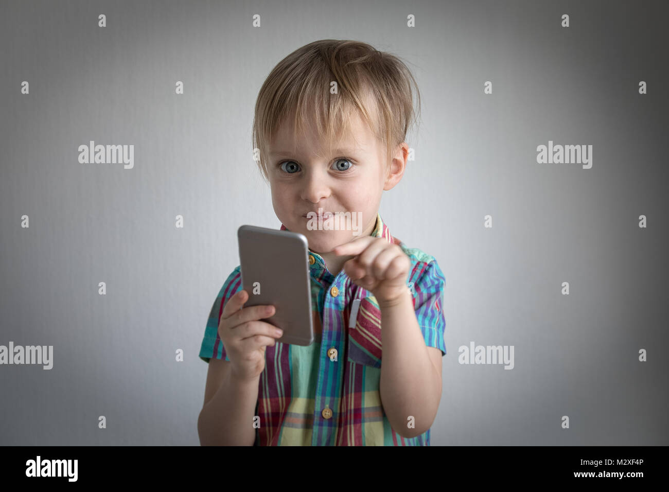 little boy with a smartphone in his hands. childs portrait Stock Photo ...