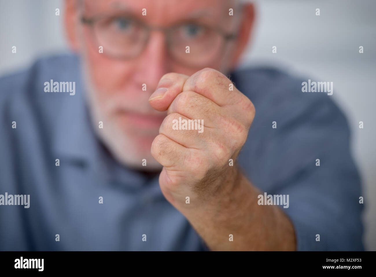 portrait of an angry man, close-up of his fist Stock Photo - Alamy