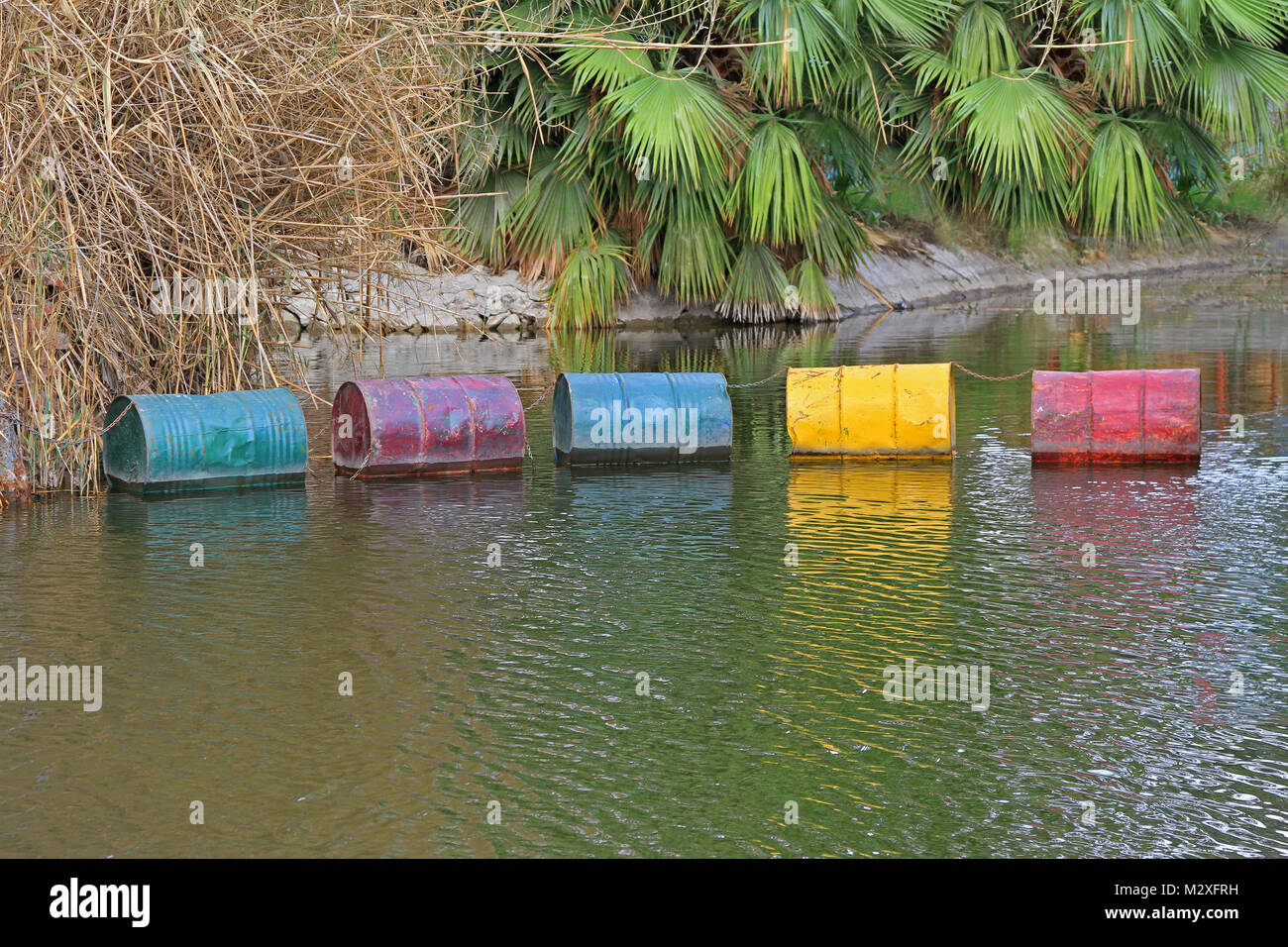 Industrial toxic waste rusty barrels tied by chain in river Stock Photo ...