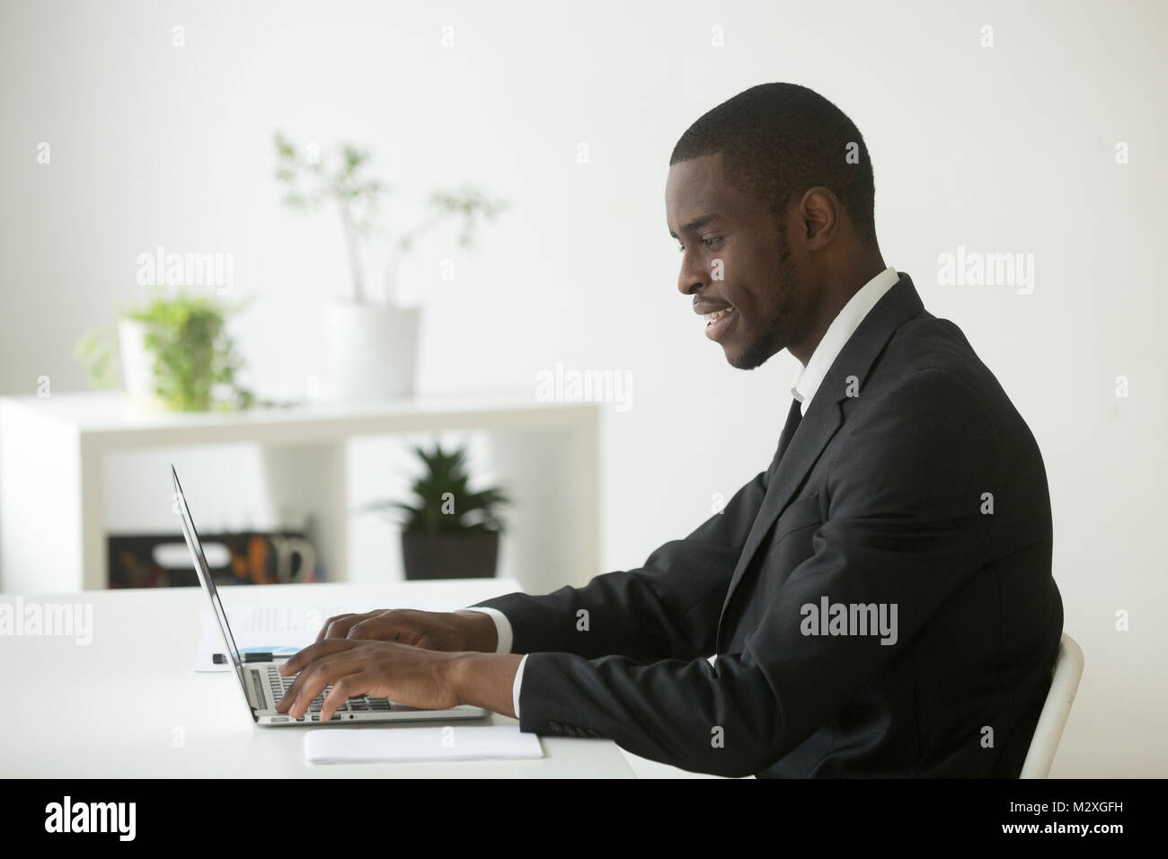 African-american attractive businessman in suit working on laptop in ...