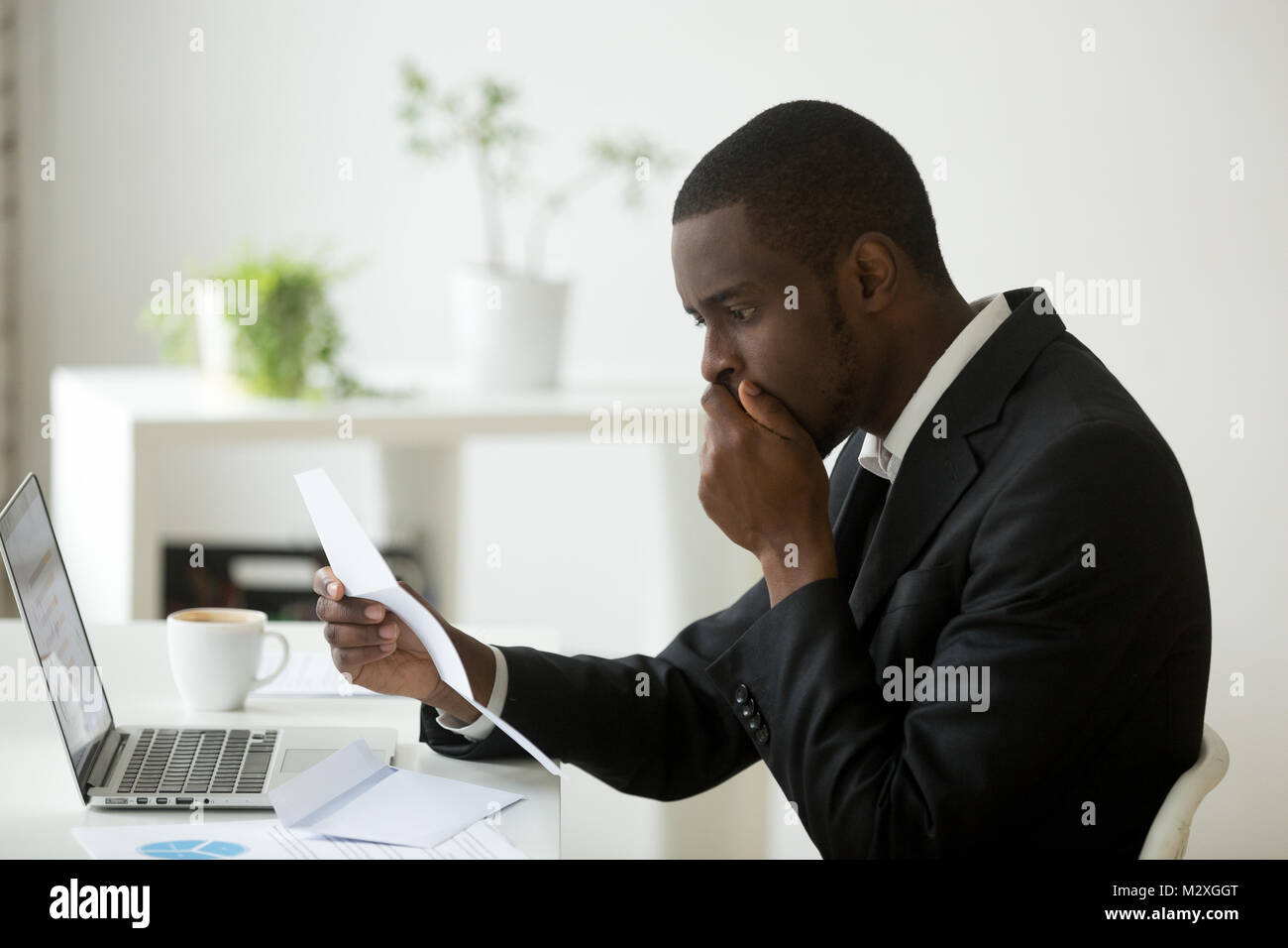 Shocked african-american businessman frustrated by notification about ...