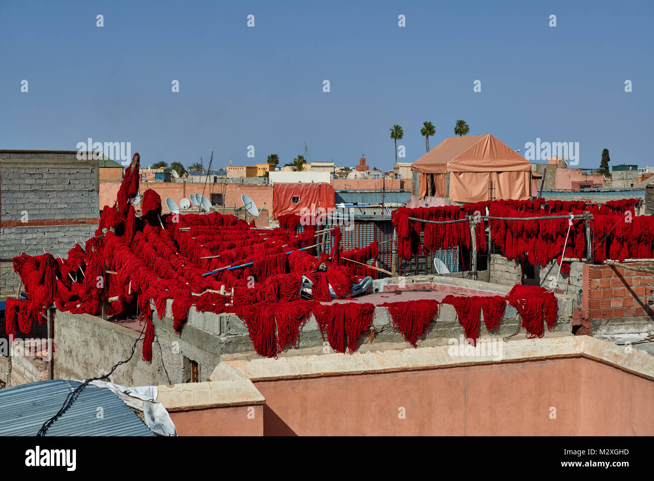 Brightly coloured wool hanging to dry in the dyers souk, textile souk ...