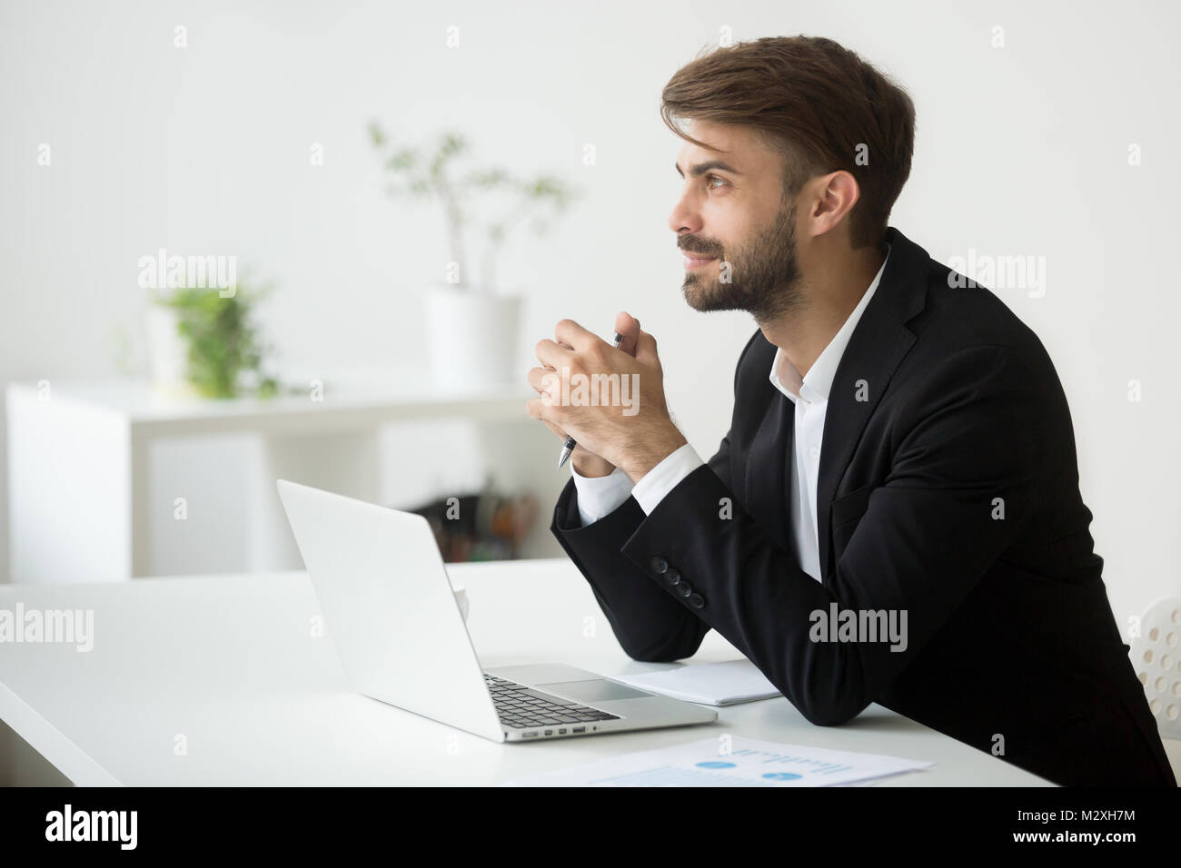 Dreamy businessman thinking of business idea planning future at Stock ...