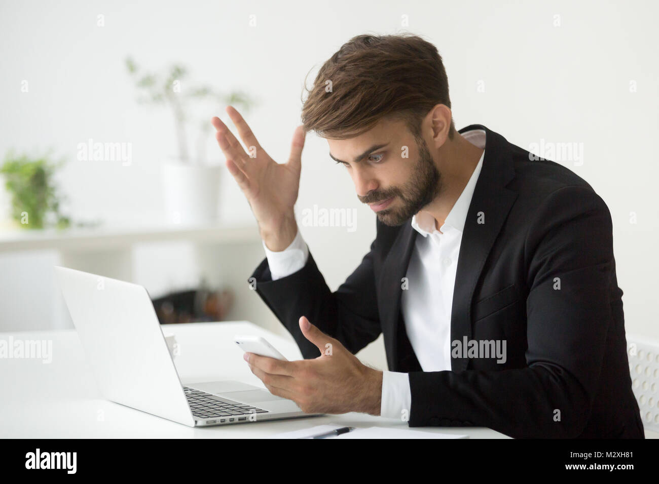Mad businessman holding laptop hi-res stock photography and images - Alamy