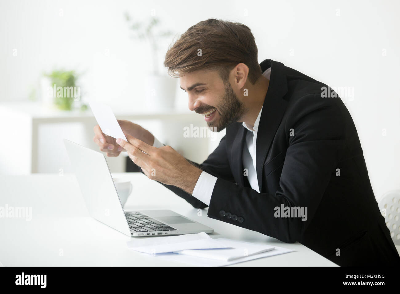 Excited successful businessman reading mail letter notice with g Stock ...