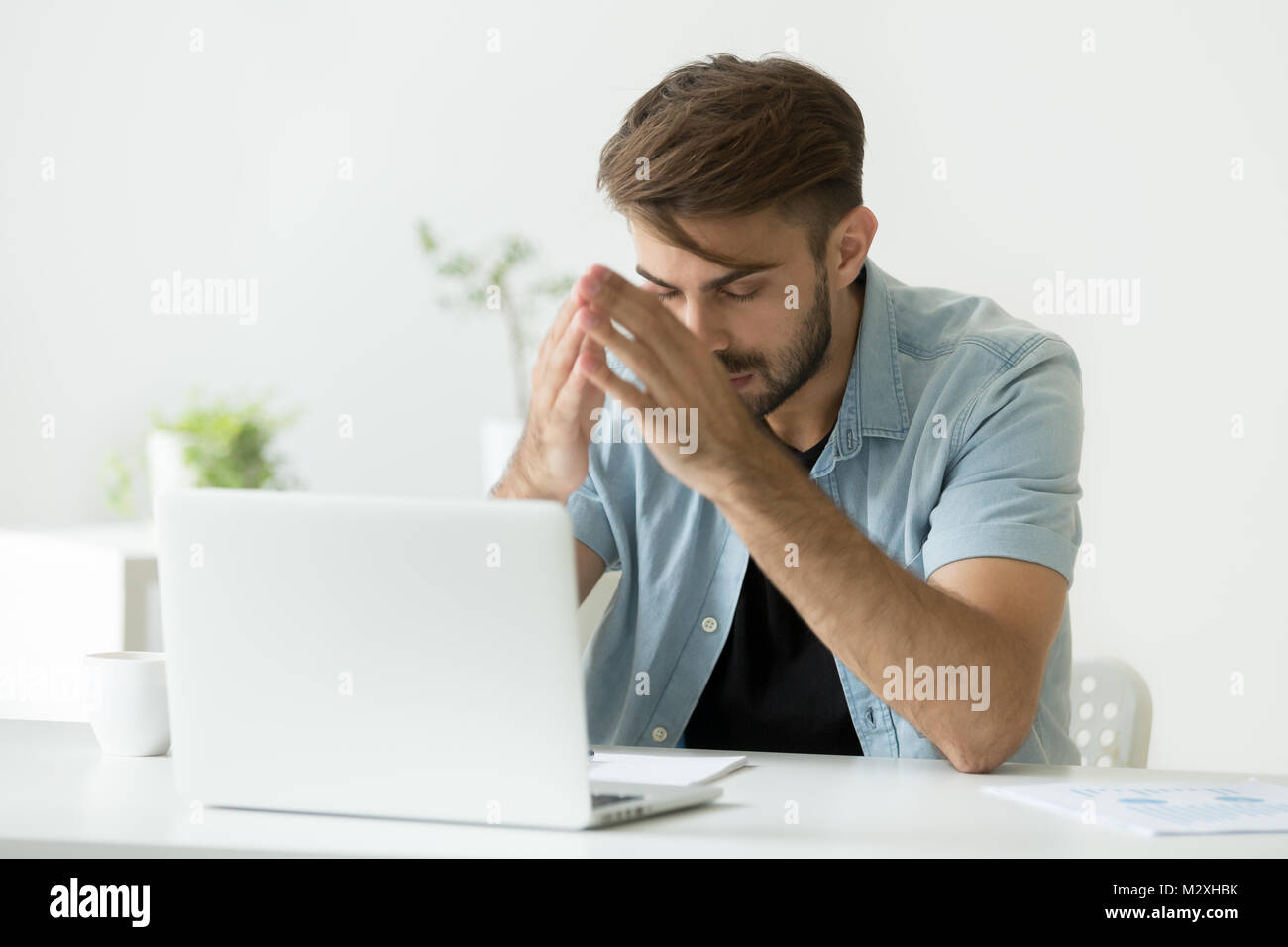 Nervous man thinking over problem trying to focus at work Stock Photo ...