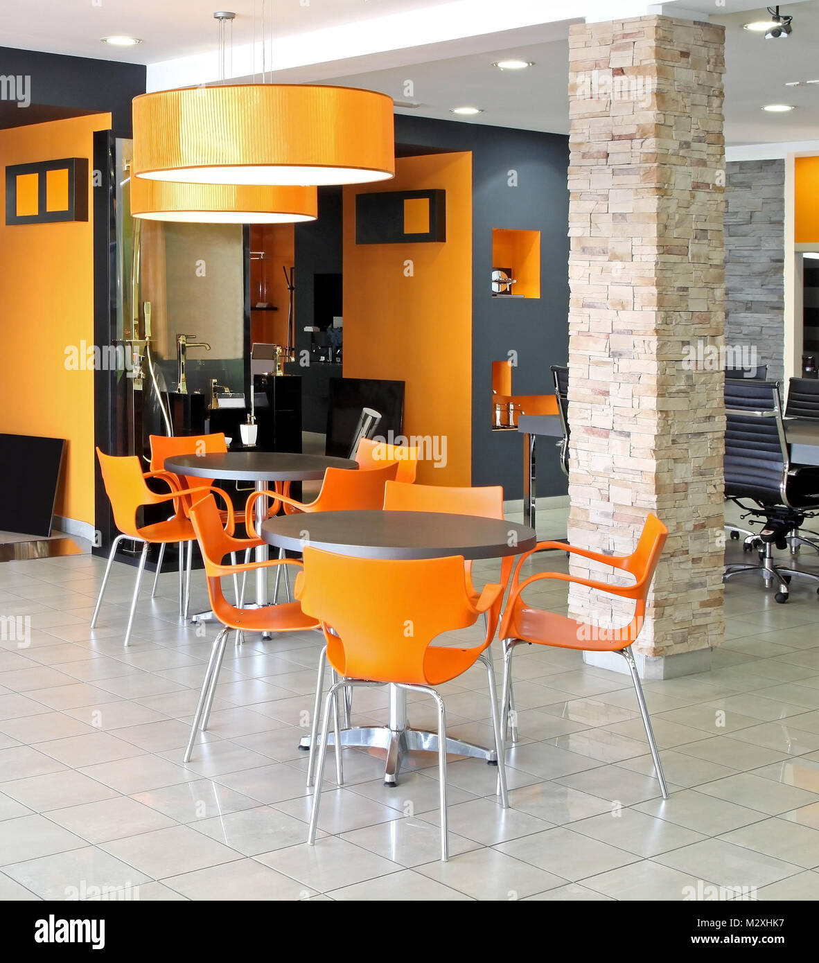 Small waiting area tables inside modern office space Stock Photo - Alamy